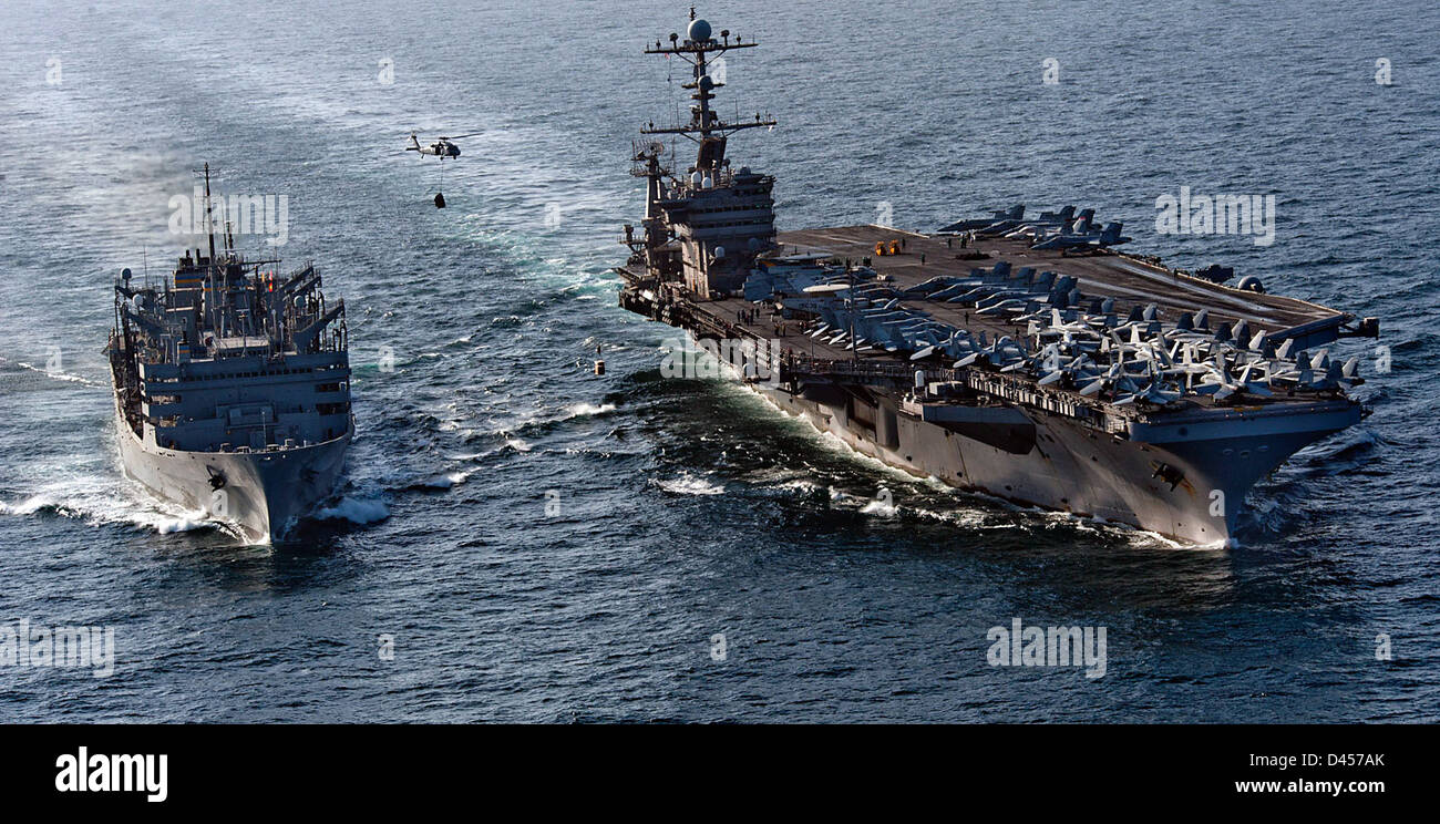 USS John C. Stennis and USNS Rainier conduct a vertical replenishment ...