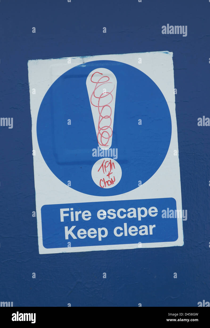 A blue Fire Escape keep clear sign coved in a blue background with two ...