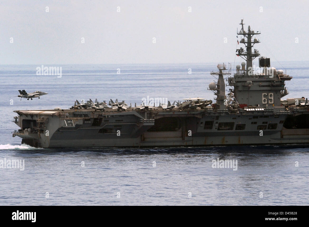 A jet lands safely on the flight deck of the USS Dwight D. Eisenhower ...