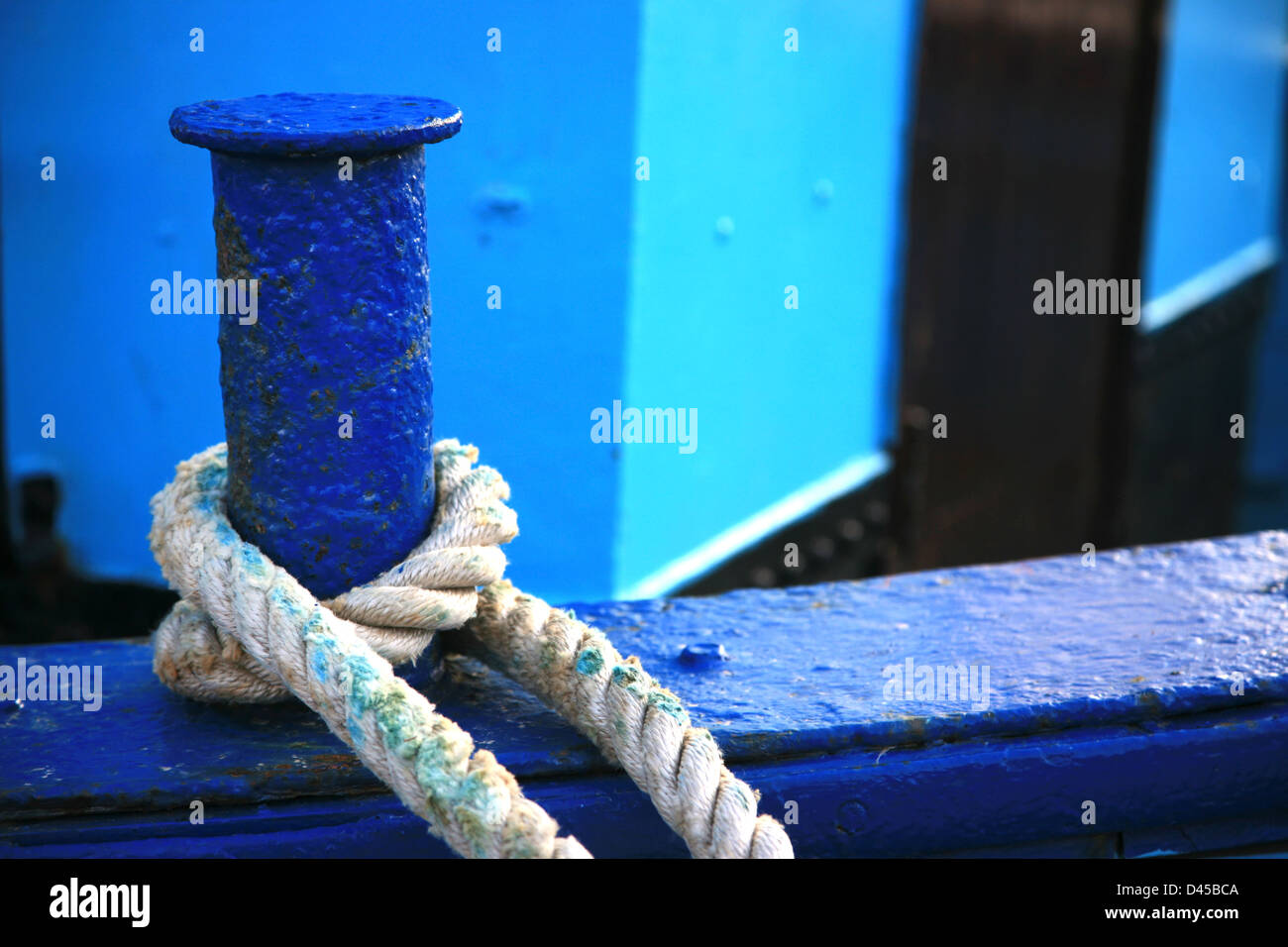 A blue boat tied with a rope Stock Photo - Alamy