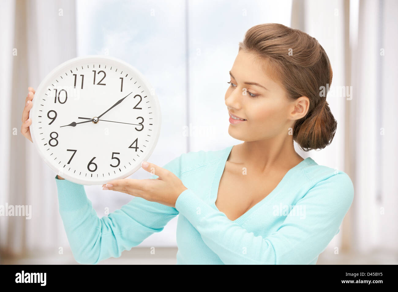 woman holding big clock Stock Photo - Alamy