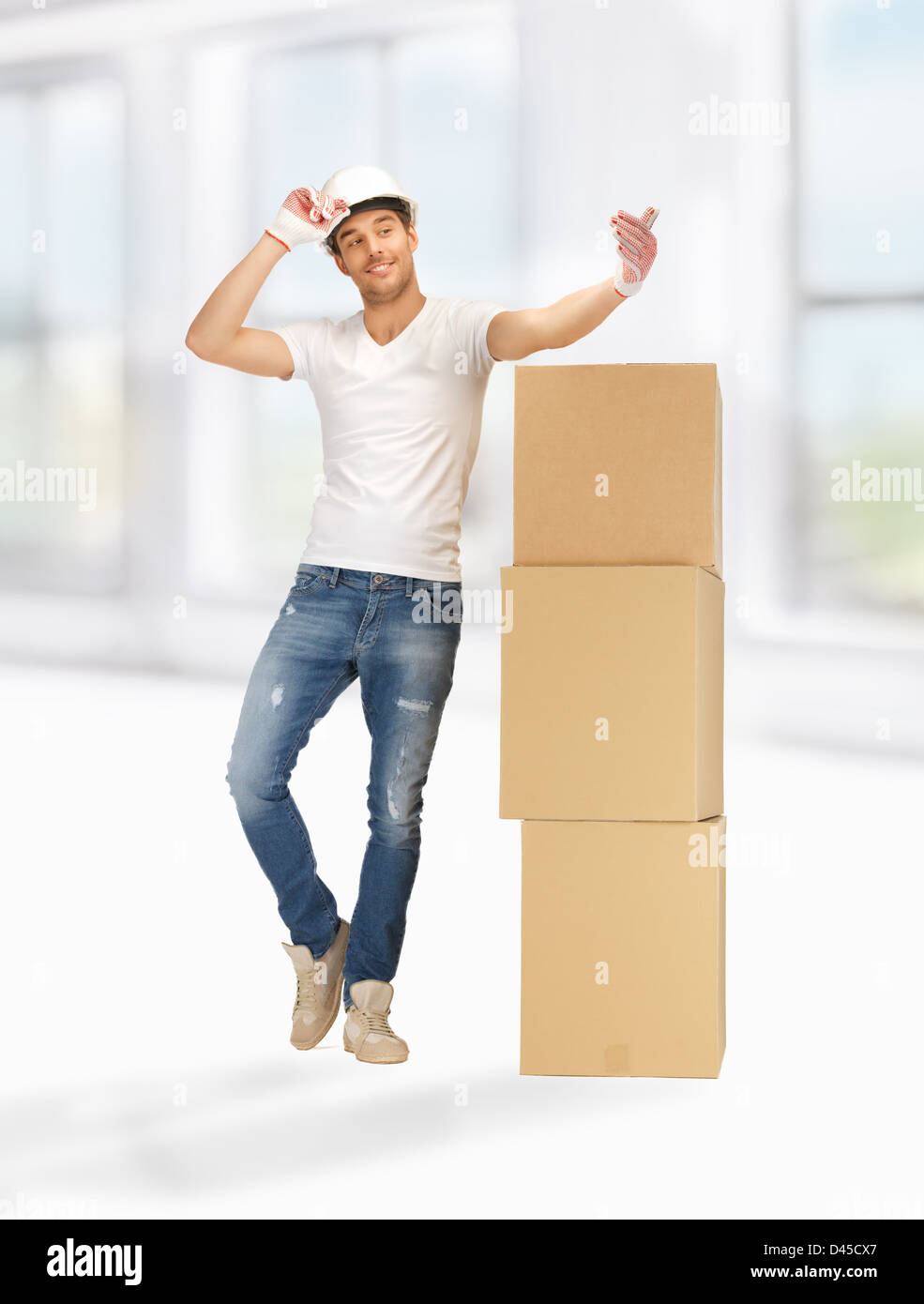 handsome builder with big boxes Stock Photo - Alamy