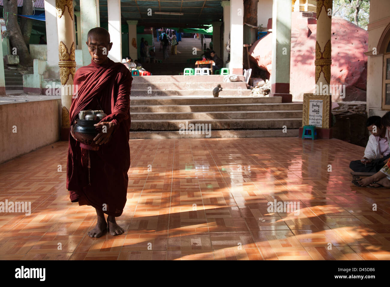 Monk walking slowly at Mt Popa,an ancient Buddhist monastery that sits ...