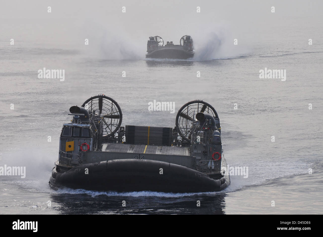 A Landing Craft Air Cushion (LCAC) approaches the well deck of a U.S ...
