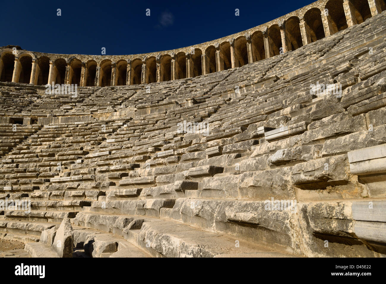 View of semicircular stone seats at ancient Roman theater Aspendos from ...