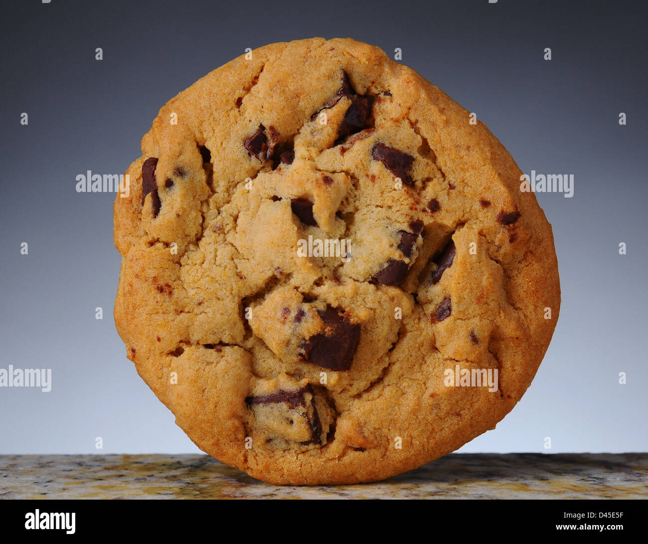 Closeup of a Chocolate Chip Cookie standing on its side on granite ...