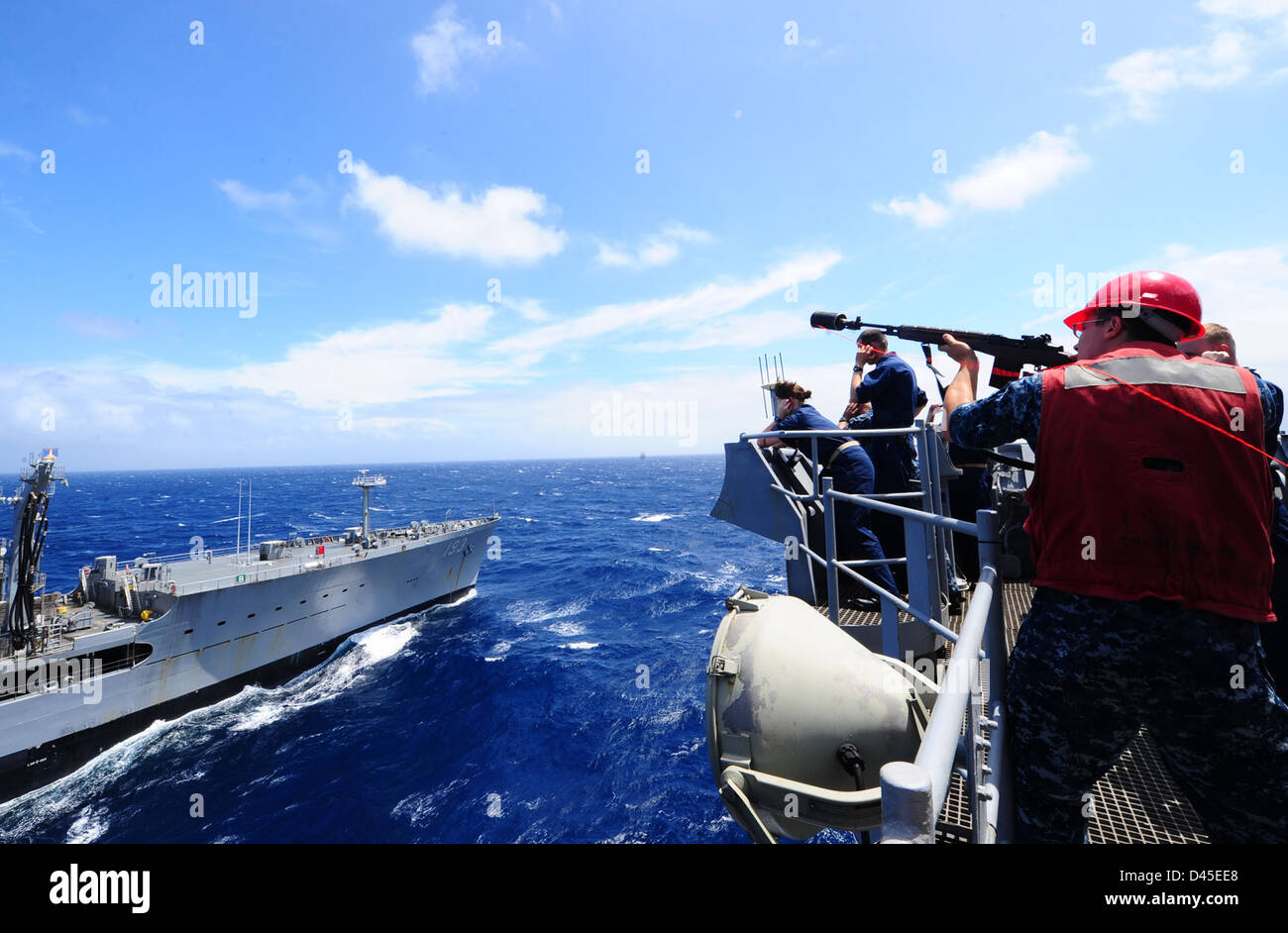 A Sailor prepares to shoot a line from USS Tortuga (LSD 46) during an ...
