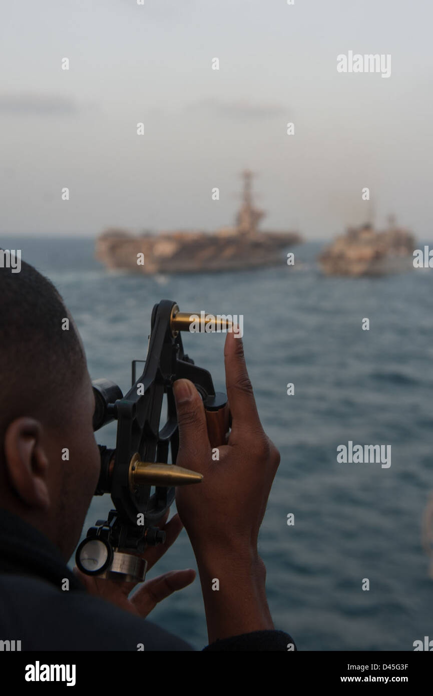 A U.S. Navy Sailor uses a stadimeter during replenishment at sea ...