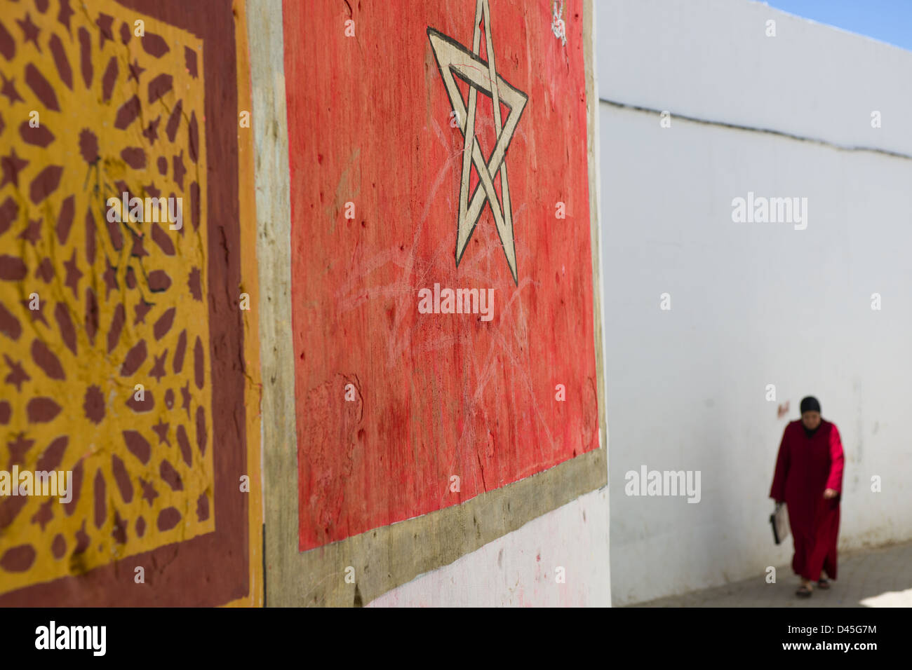 Brightly coloured murals painted on white walls in the old town of ...