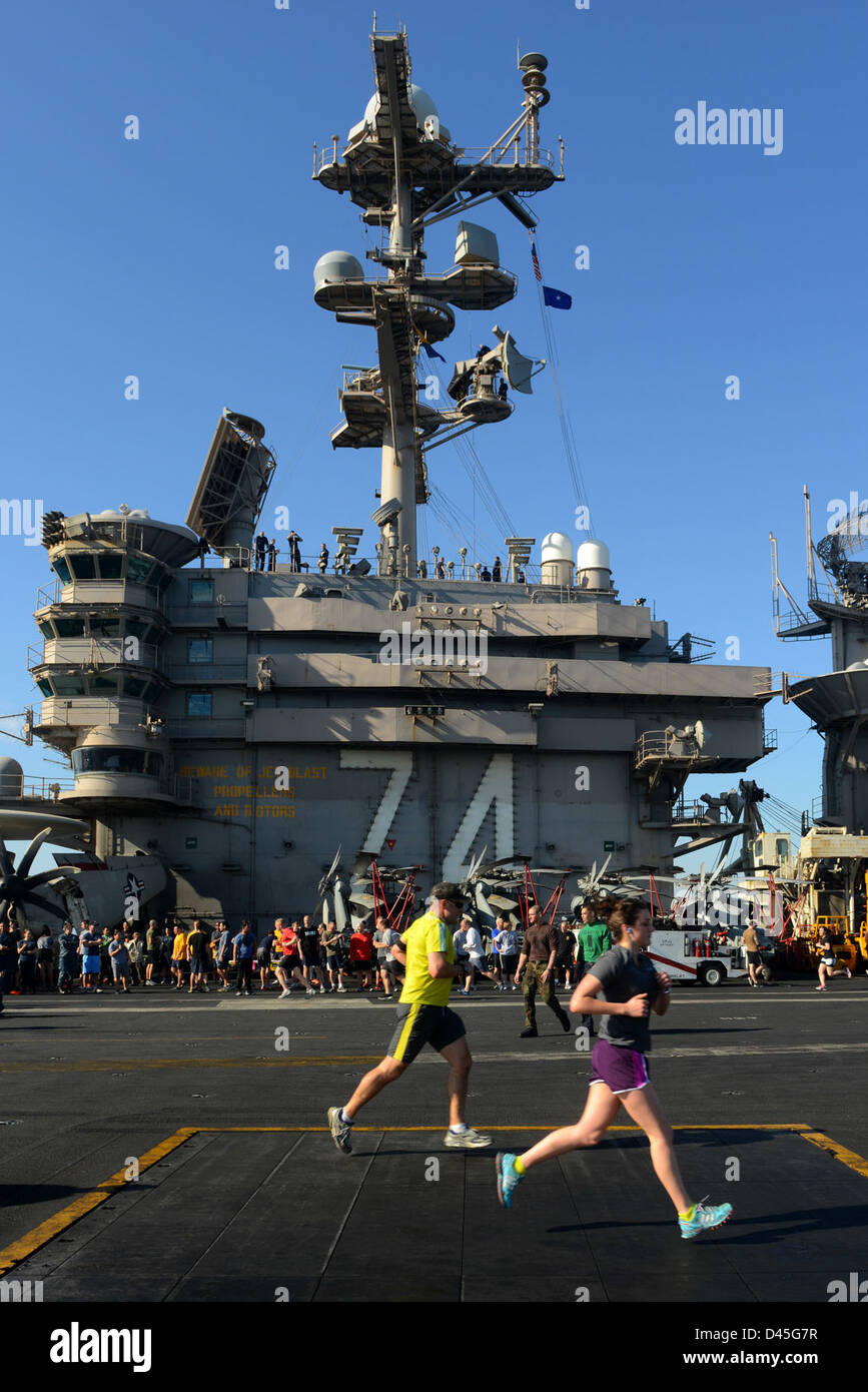 Sailors aboard the USS John C. Stennis participate in a 5K race as part ...