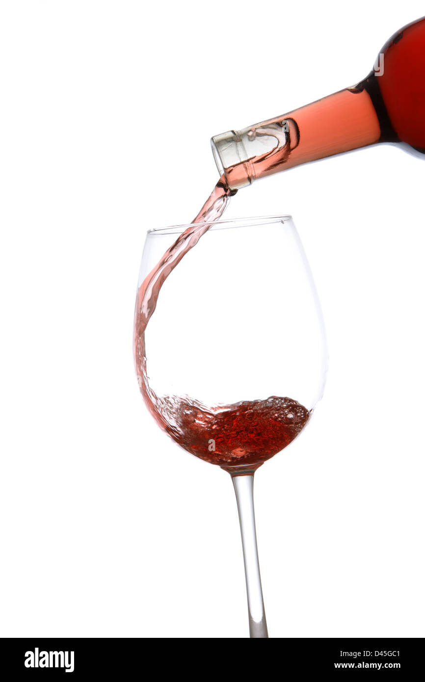 Pouring wine into a glass in the studio Stock Photo - Alamy