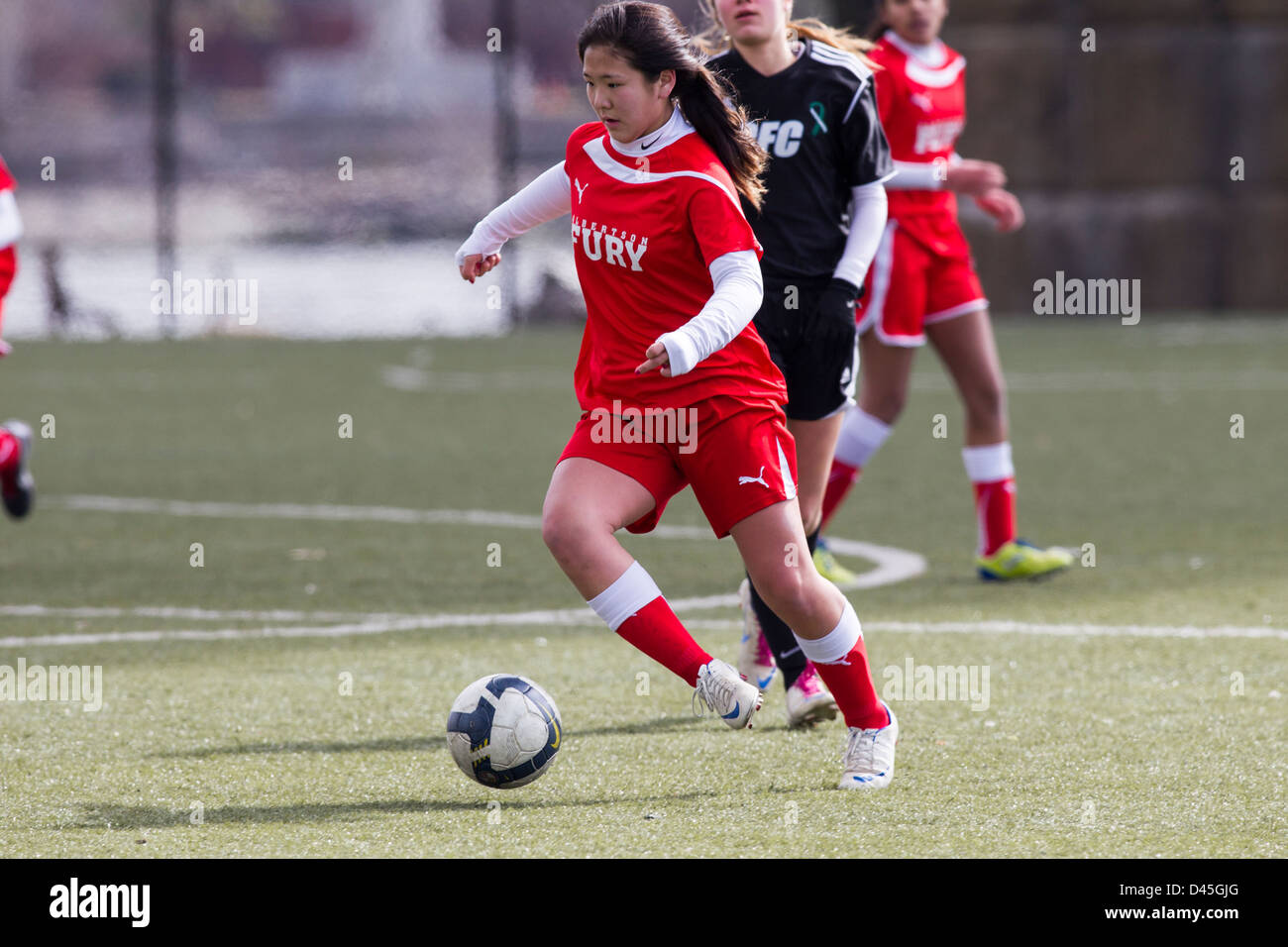 Teen girls soccer action Stock Photo - Alamy