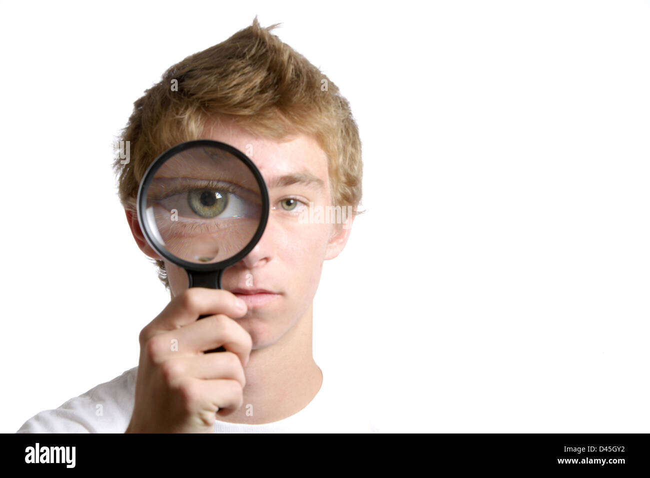 Man looking threw a magnifying glass in the studio Stock Photo - Alamy