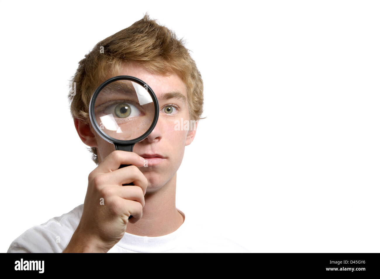 Man looking threw a magnifying glass in the studio Stock Photo - Alamy