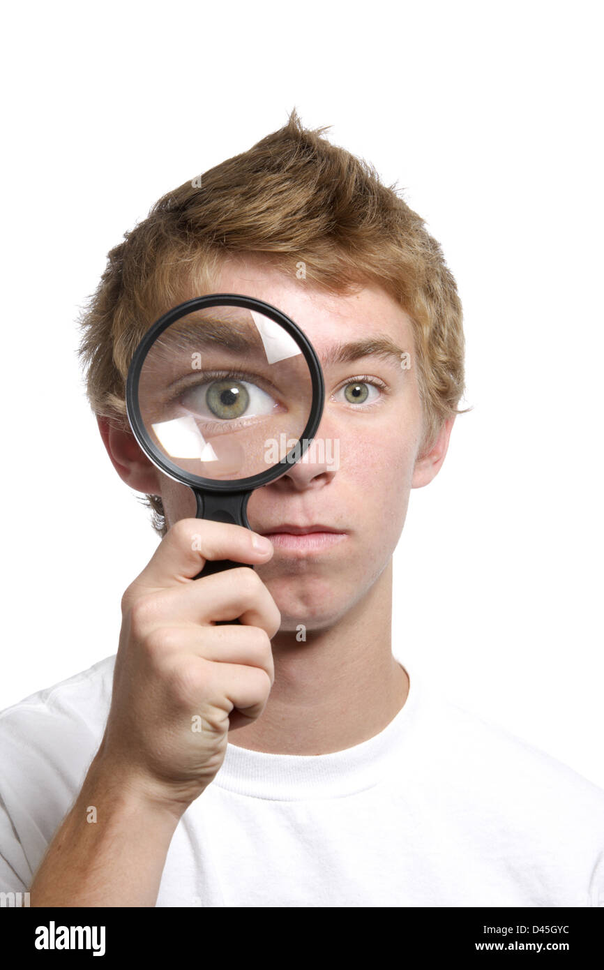 Man looking threw a magnifying glass in the studio Stock Photo - Alamy