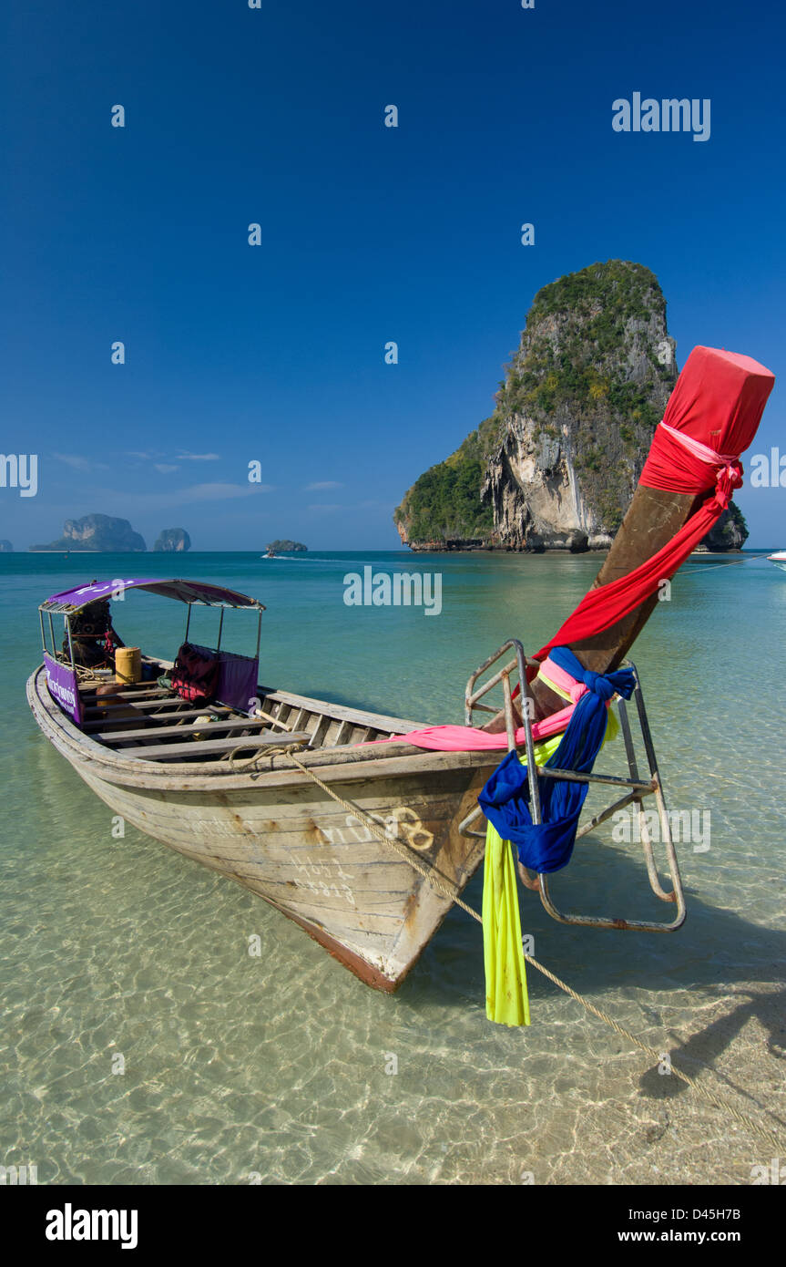 Traditional Thai longtail fishing boat moored on Phra Nang Beach, Ao Nang, near Krabi, Thailand ...