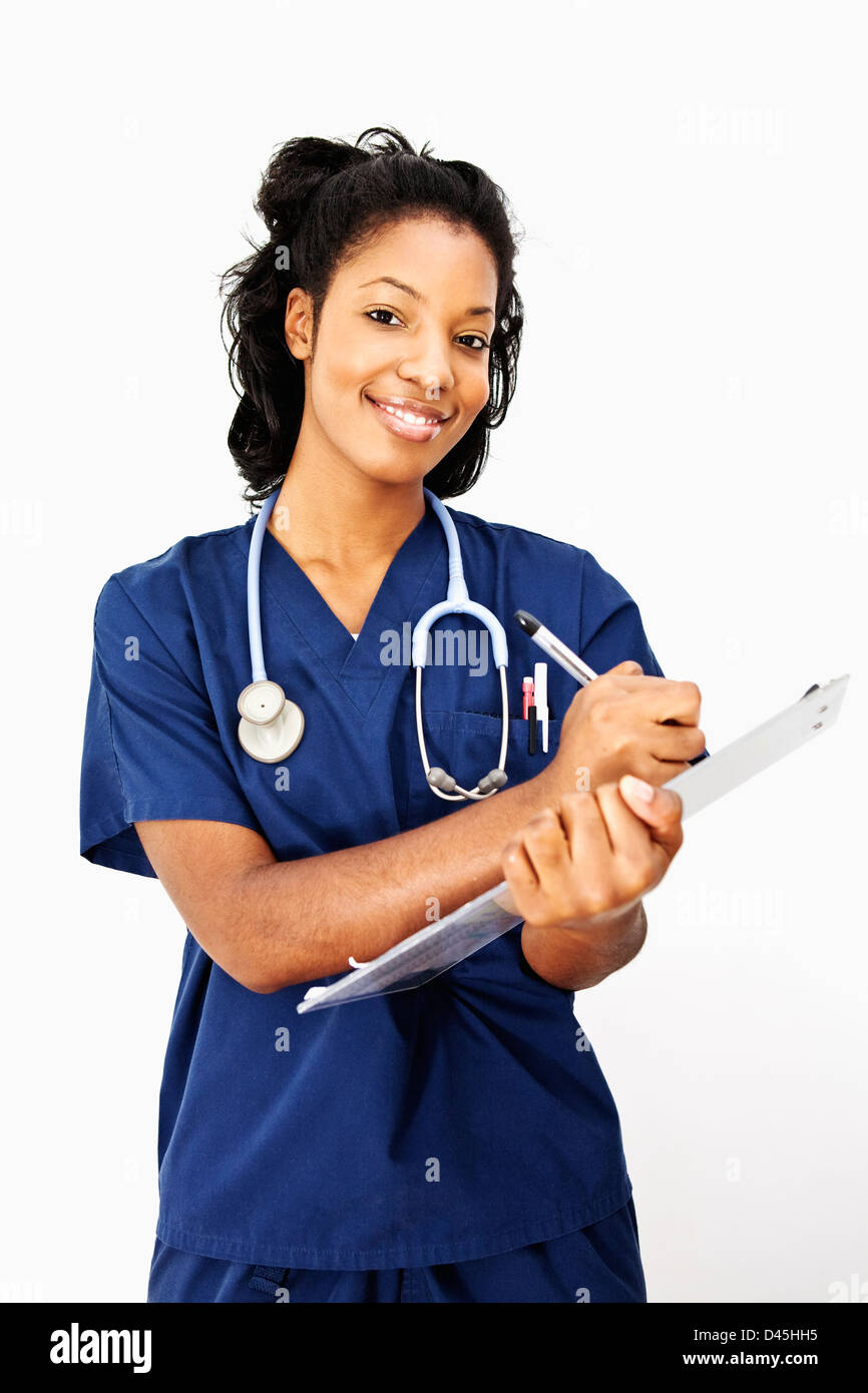 A smiling young nurse taking notes Stock Photo - Alamy