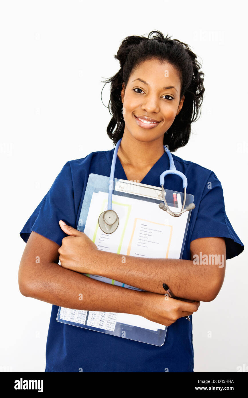 A smiling young woman in nurse uniform, with a stetoscope on her neck ...