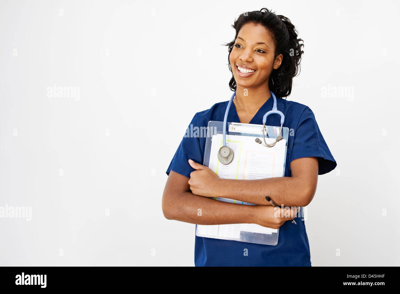 A smiling young woman in nurse uniform, with a stethoscope on her neck ...