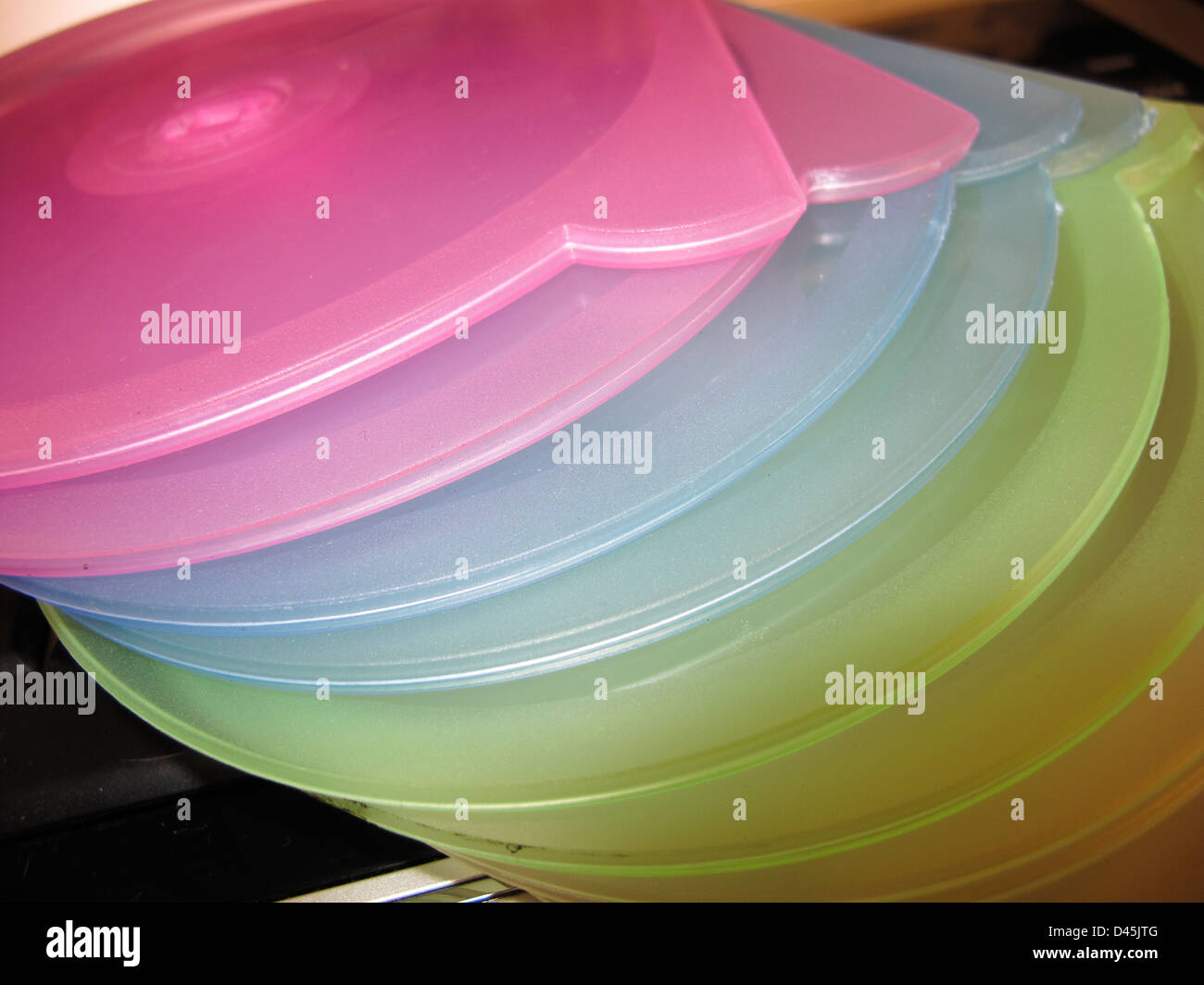 Stack of coloured plastic CD cases on laptop Stock Photo - Alamy
