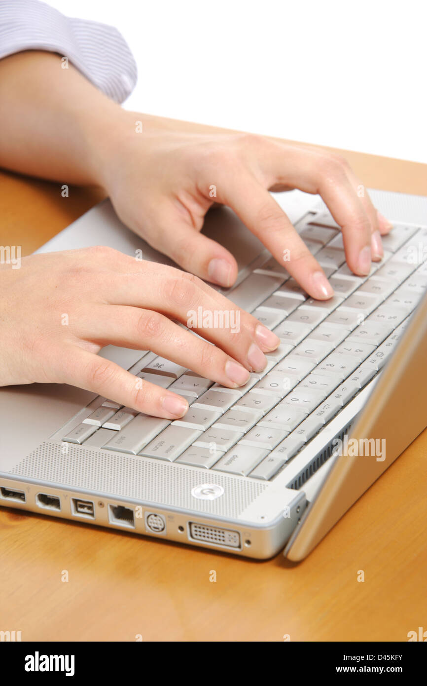 A person typing on a laptop keyboard Stock Photo - Alamy