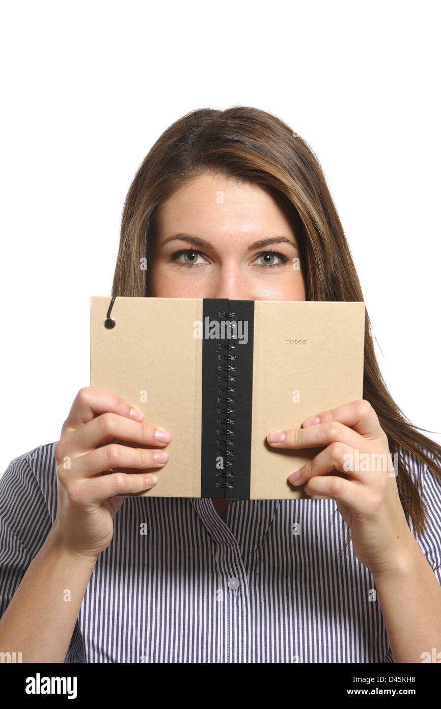 A woman looking over a note book in the studio Stock Photo - Alamy