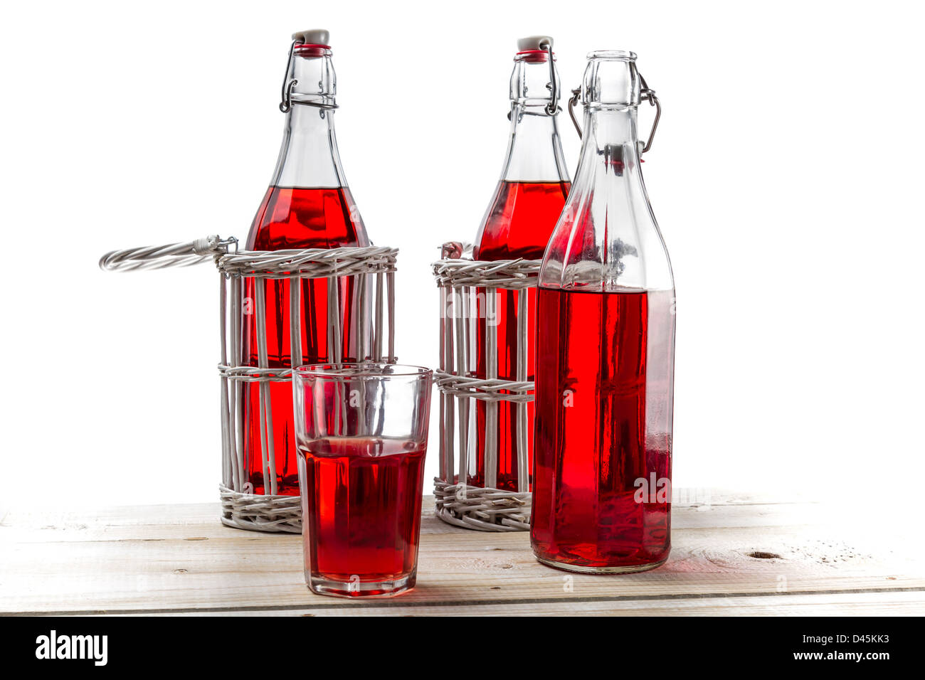 Vintage bottles with red juice on white background Stock Photo - Alamy