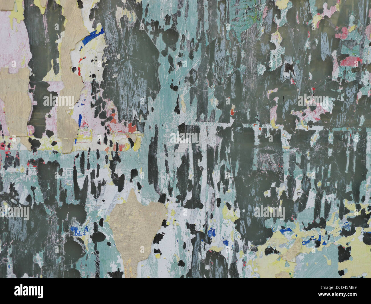 piece of paper posters scratched from the wall Stock Photo - Alamy