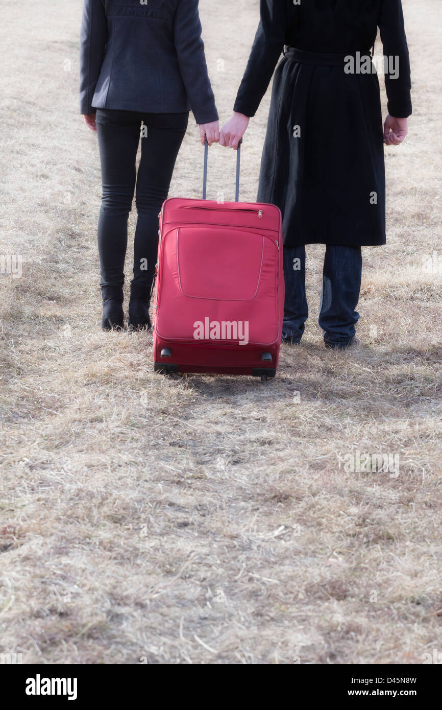 Woman pulling travel suitcase hi-res stock photography and images - Alamy