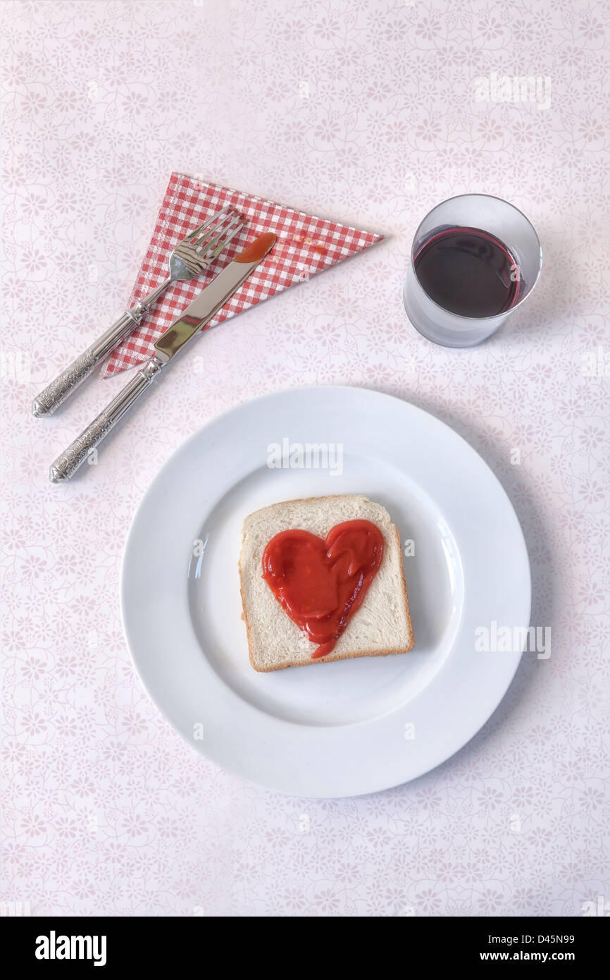 a slice of toast with a heart of ketchup Stock Photo - Alamy