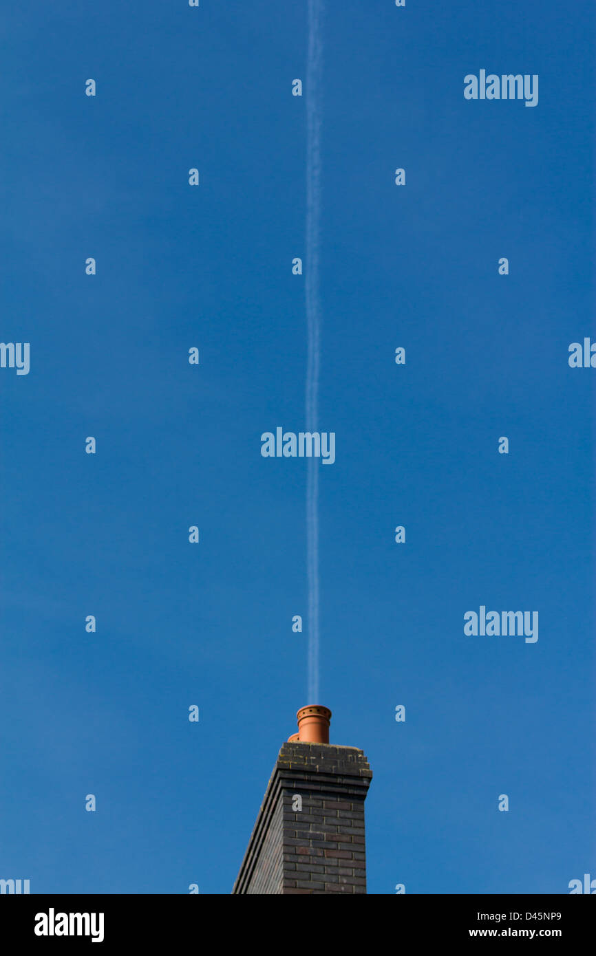 Airoplane train heading straight into a chimney, on a bright blue sunny ...