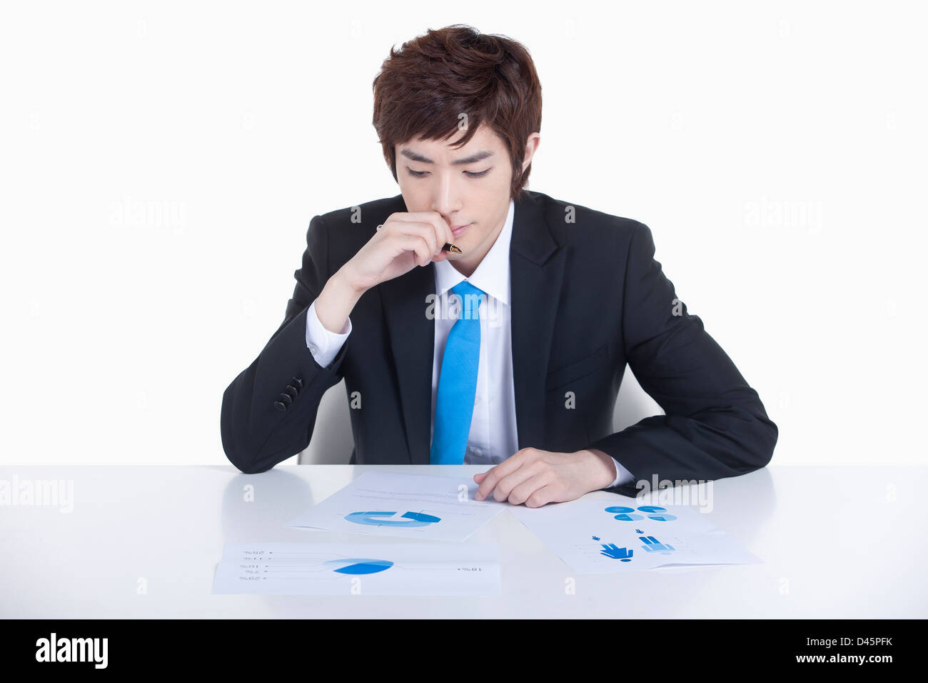 a businessman looking at chart papers Stock Photo - Alamy
