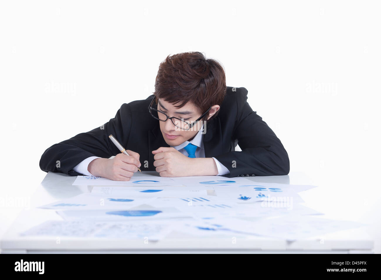 a businessman studying chart papers Stock Photo - Alamy