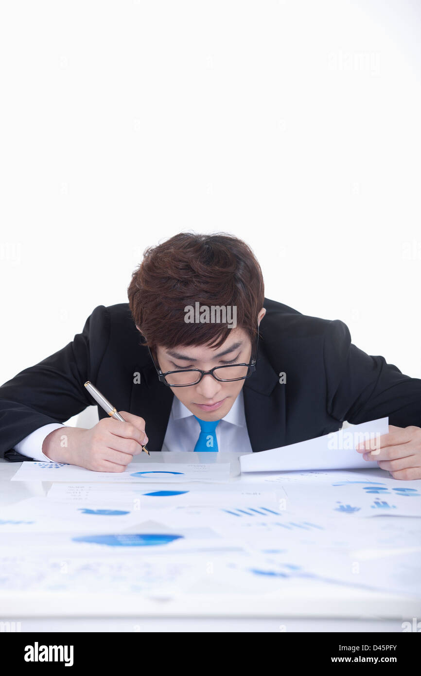 a businessman studying chart papers Stock Photo - Alamy