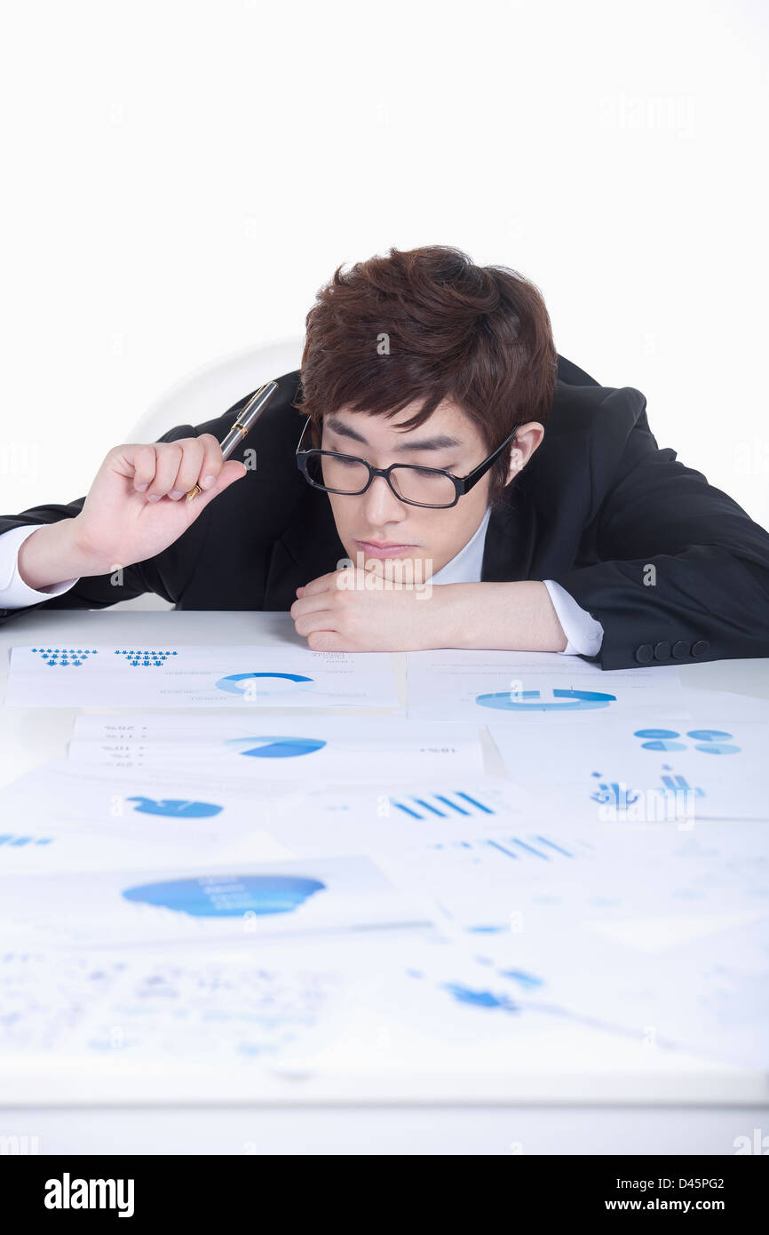a businessman studying chart papers Stock Photo - Alamy