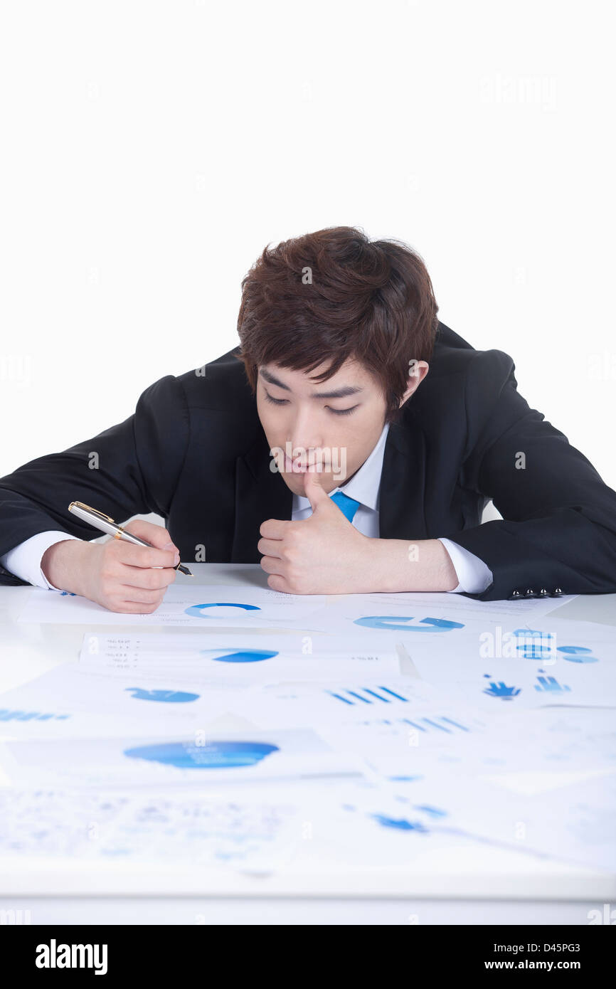 a businessman studying chart papers Stock Photo - Alamy