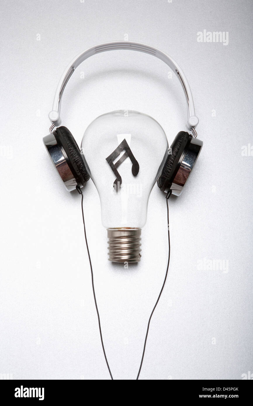 headsets over a light bulb with musical note Stock Photo - Alamy
