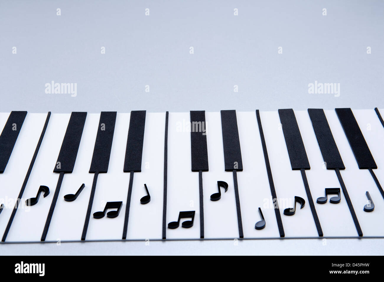 musical notes on a piano keyboard Stock Photo - Alamy