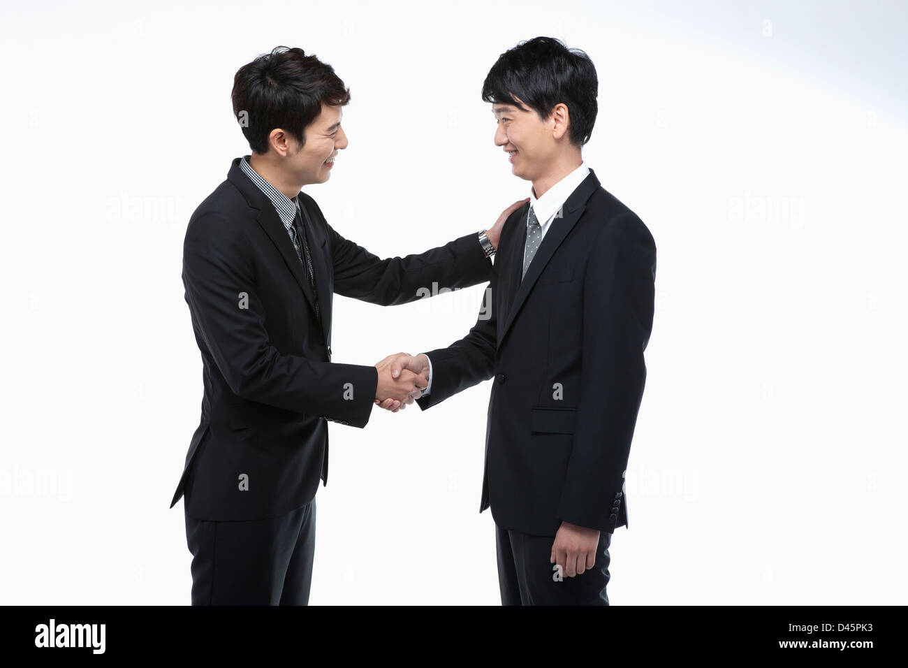 two young businessmen greeting each other Stock Photo - Alamy