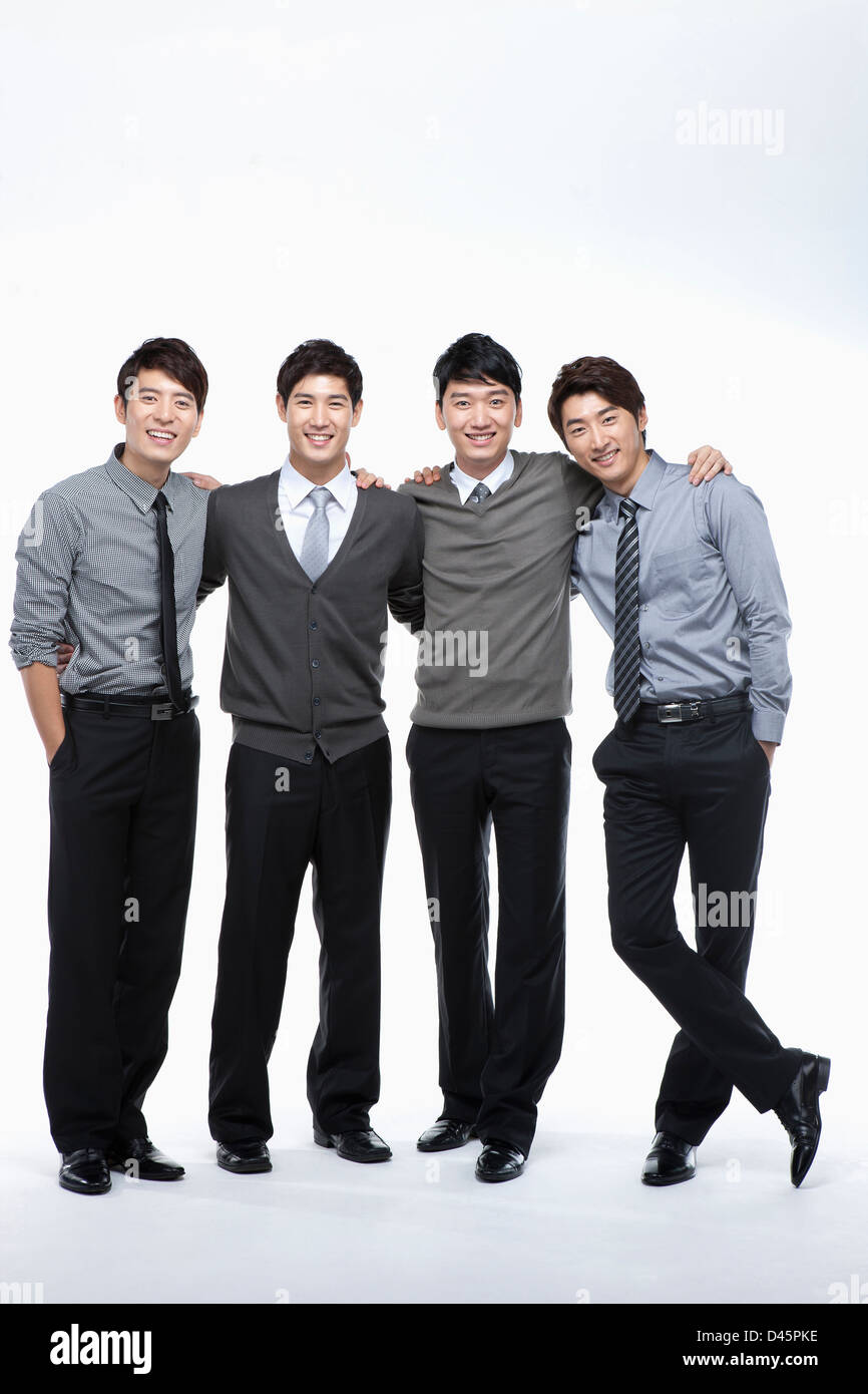 four businessman standing arm in arm Stock Photo - Alamy