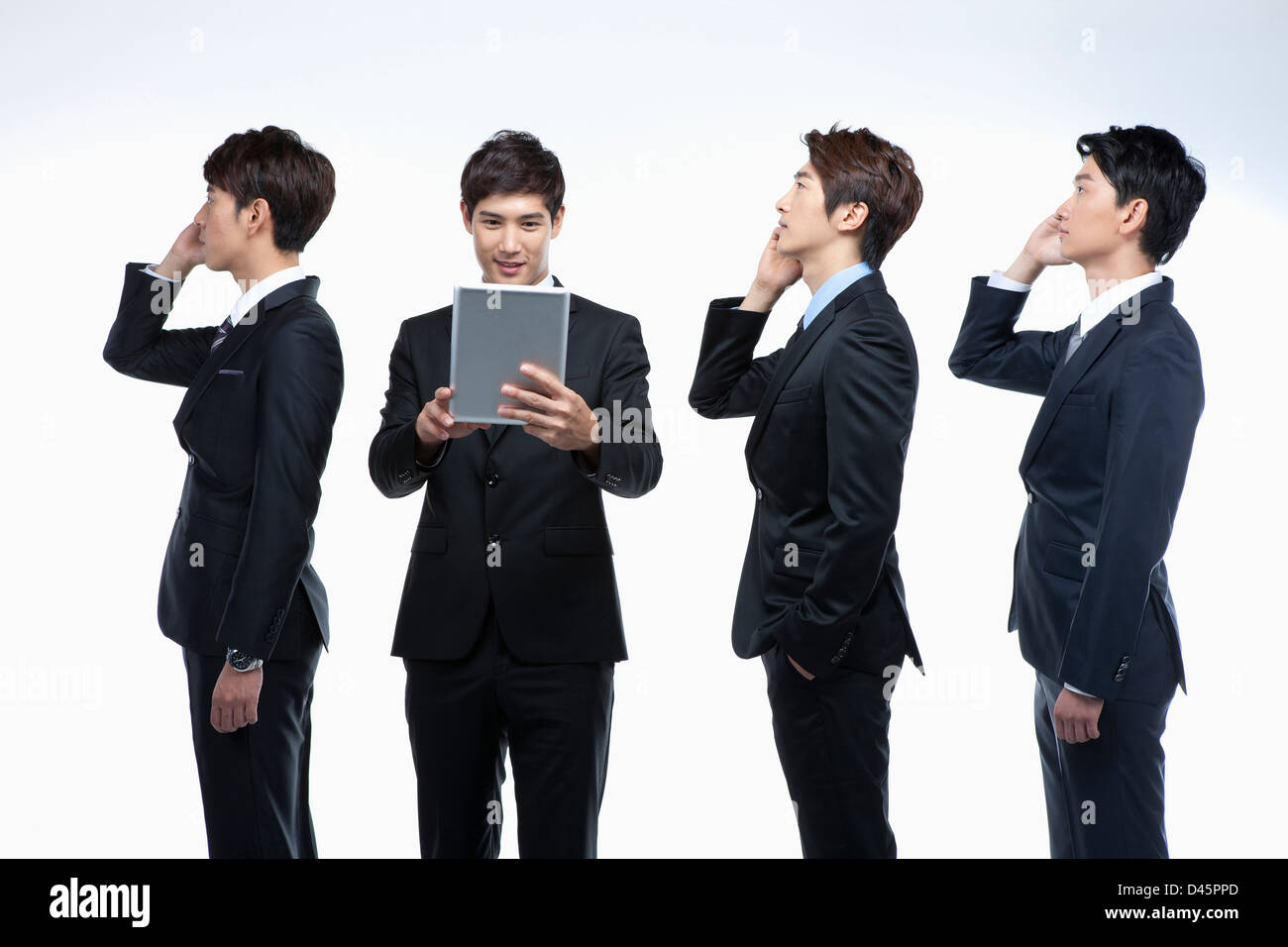 a businessman using PC tablet while other businessmen saluting in a ...