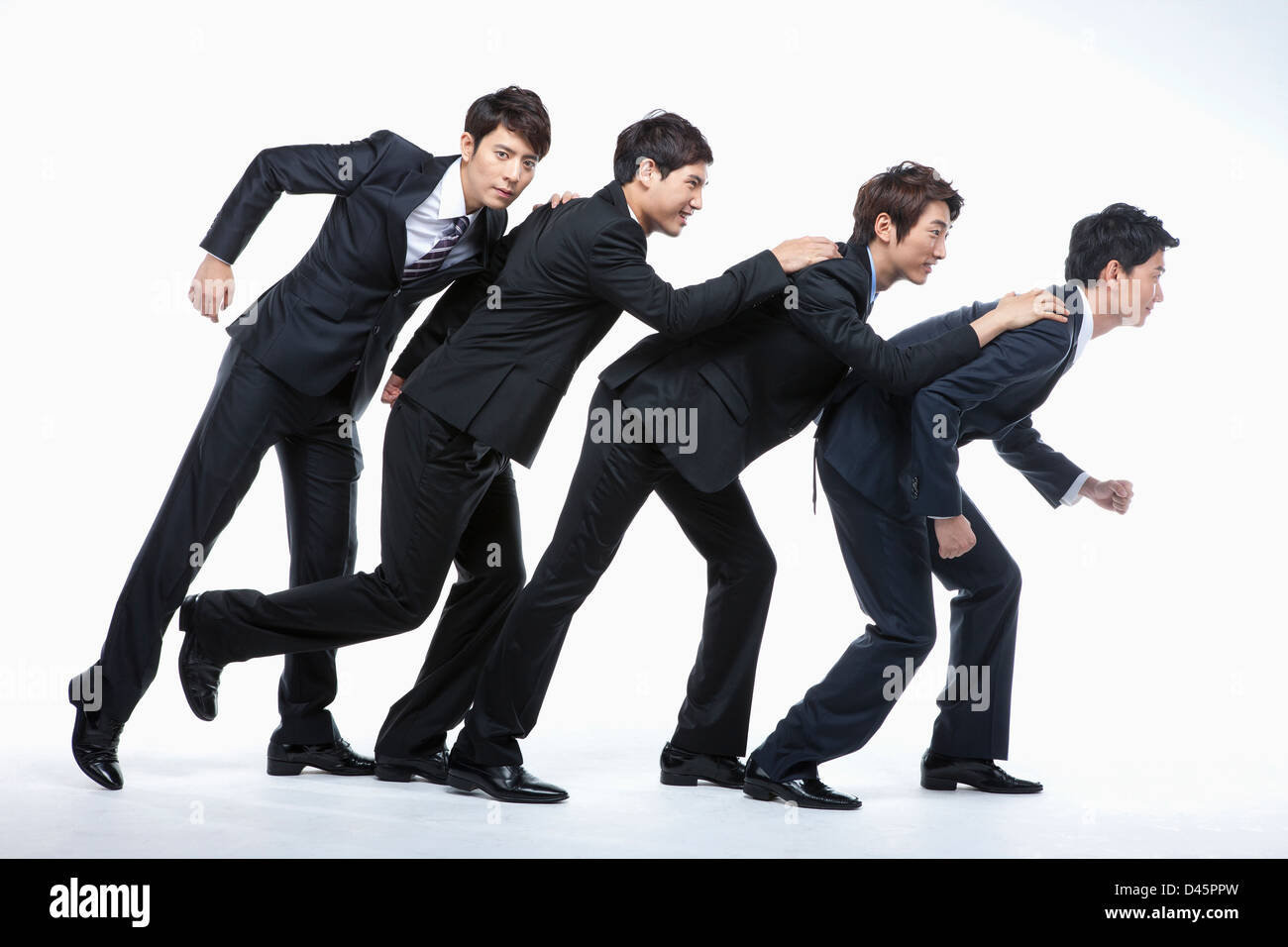 businessman in a line trying to reach further Stock Photo - Alamy