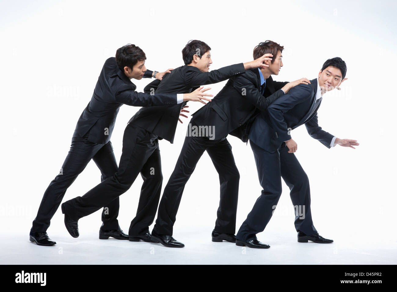 businessman in a line trying to reach further Stock Photo - Alamy