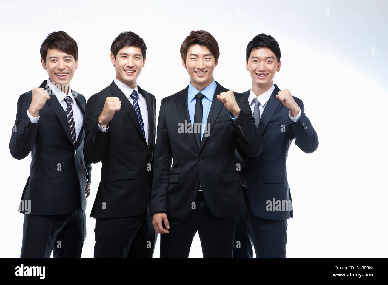 four businessmen in cheering pose Stock Photo - Alamy