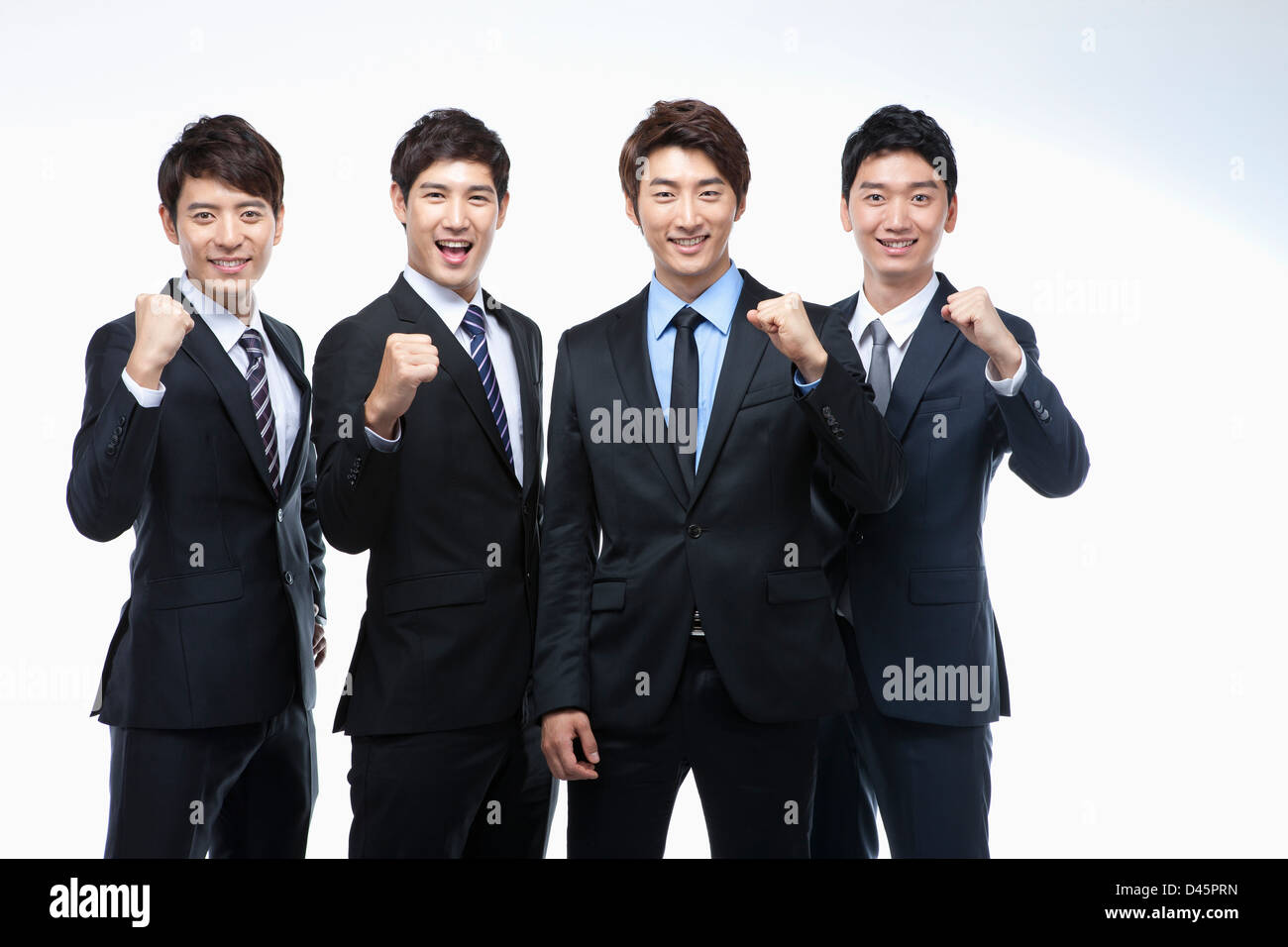 four businessmen in cheering pose Stock Photo - Alamy