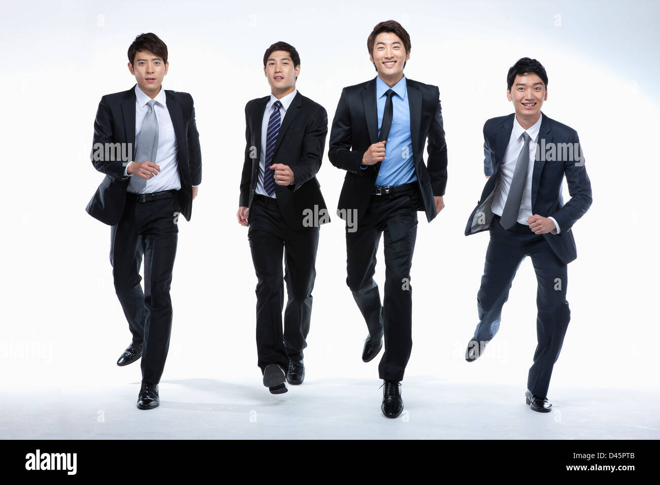 businessmen in business suit running together Stock Photo - Alamy
