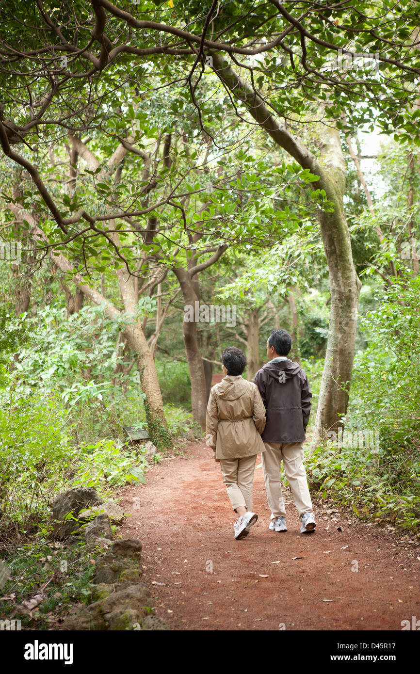 back shot of middle age couple talking a walk together in nature Stock ...