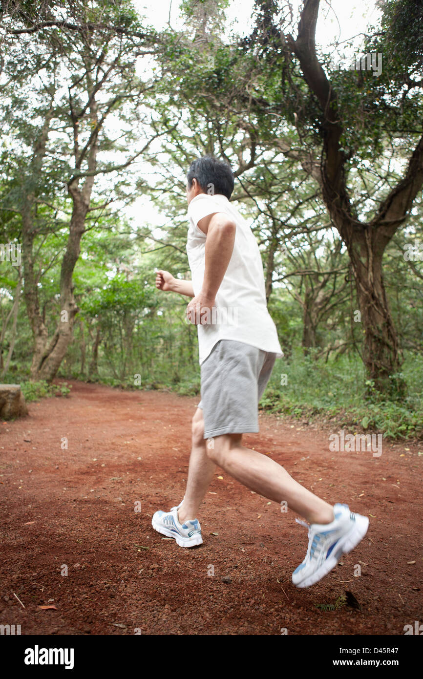 middle age man jogging in nature Stock Photo - Alamy