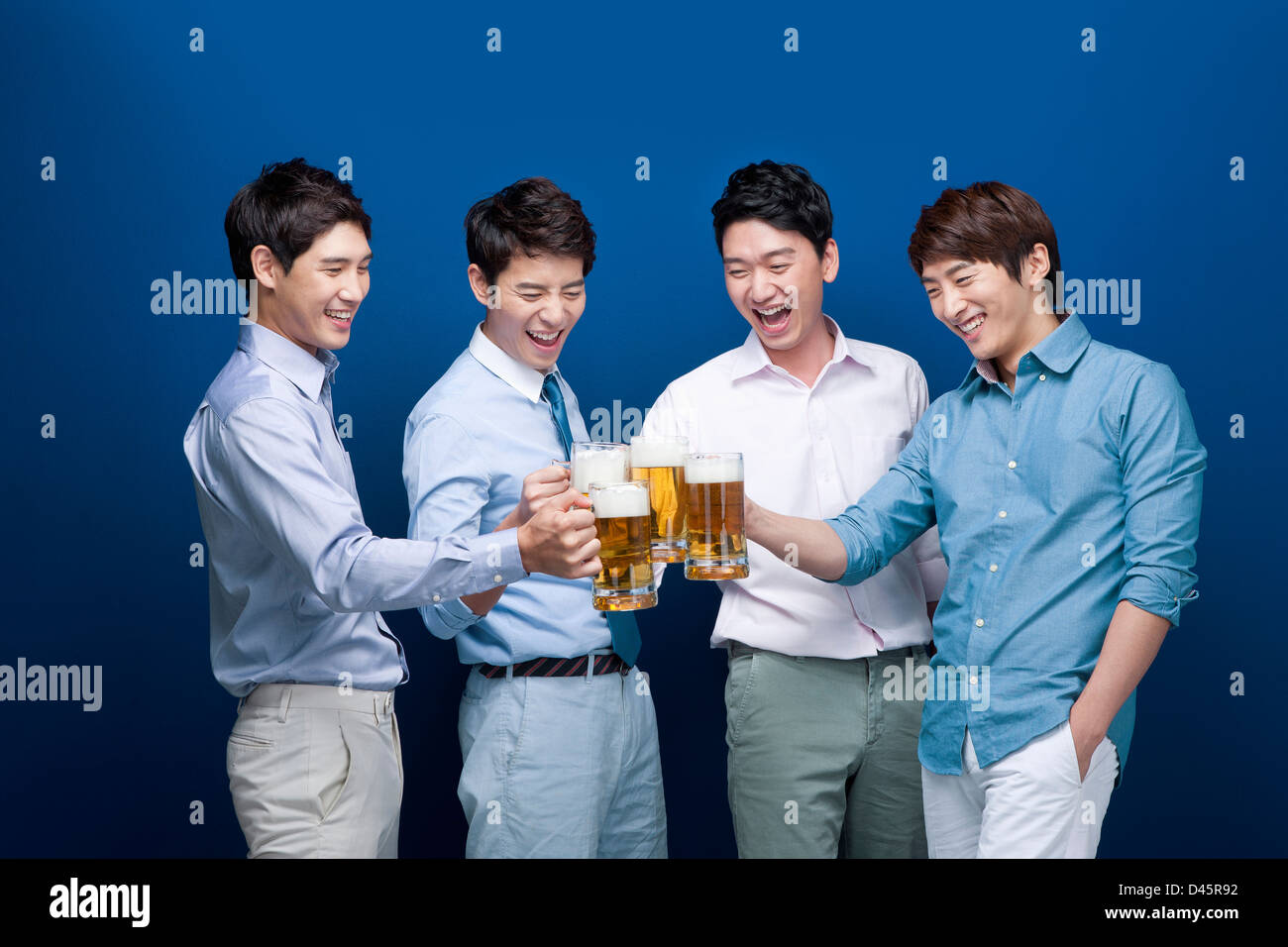 four businessmen toasting with beer Stock Photo - Alamy