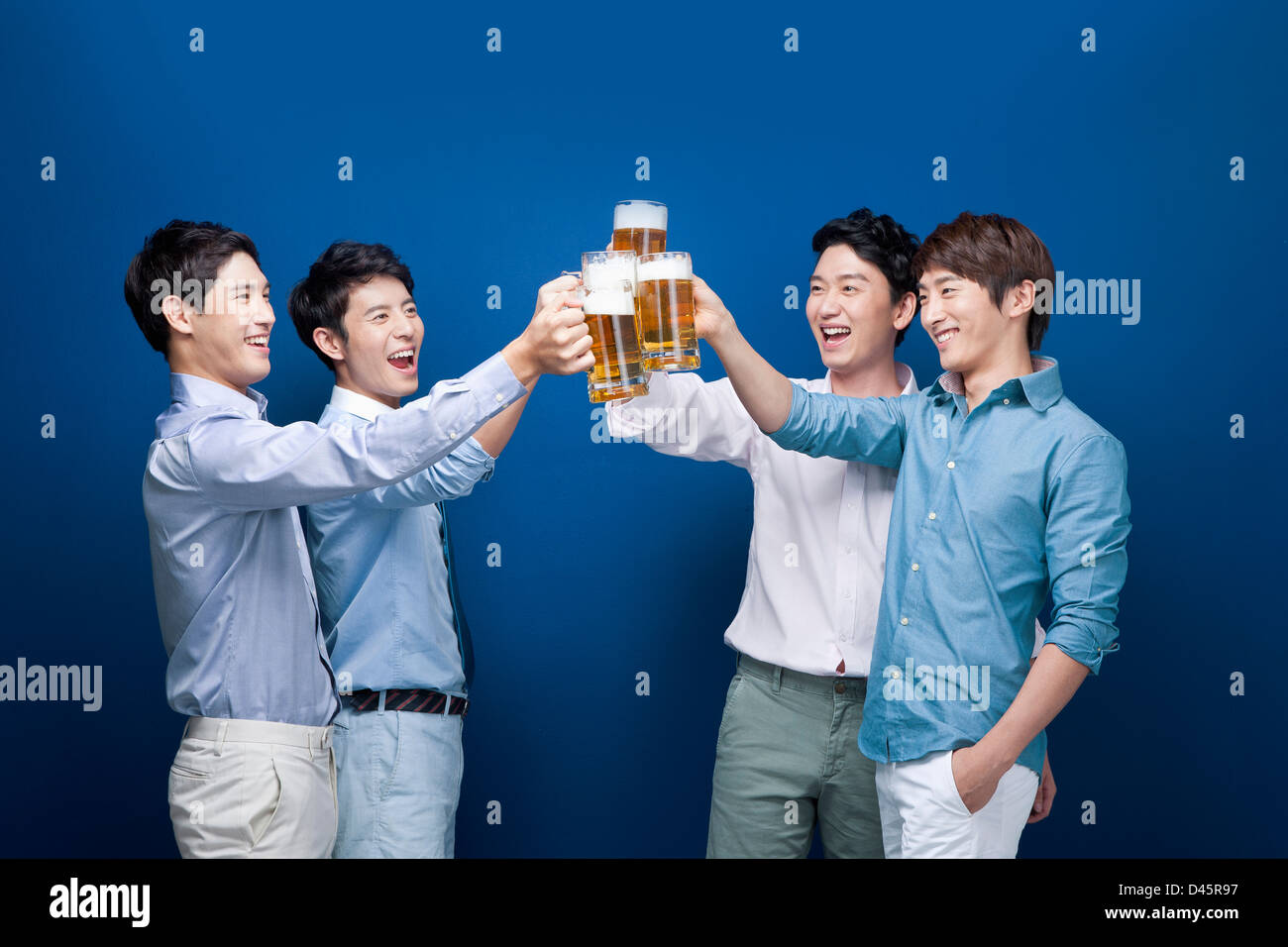 four businessmen toasting with beer Stock Photo - Alamy
